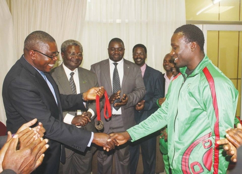 DEPUTY Minister of Youth and Sport Christopher Mulenga congratulates ...
